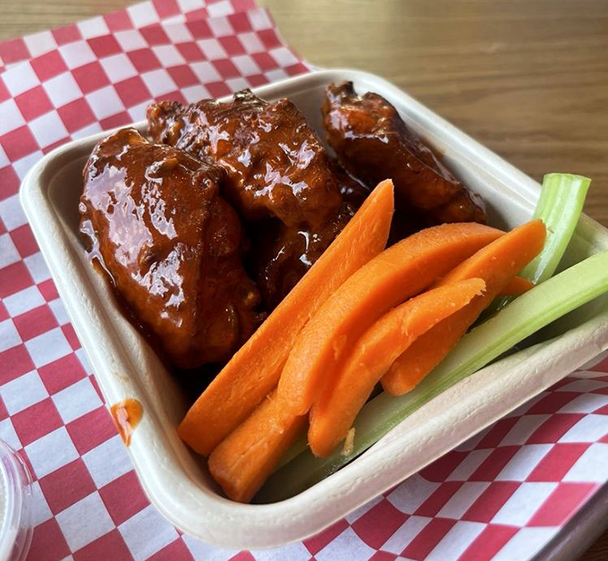 Even the wings get the royal treatment&mdash;glossy, sticky-sweet sauce with the classic carrot and celery sidekicks standing by for cooldown duty.