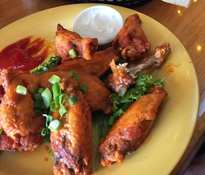 Buffalo wings that don't mess around &ndash; crispy, saucy, and garnished with green onions that add a fresh pop to this bar food classic.