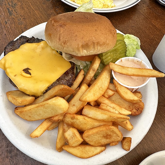 This isn't just a burger—it's a hand-formed statement of diner philosophy: simple ingredients, executed perfectly, with fries that could make a Frenchman weep.