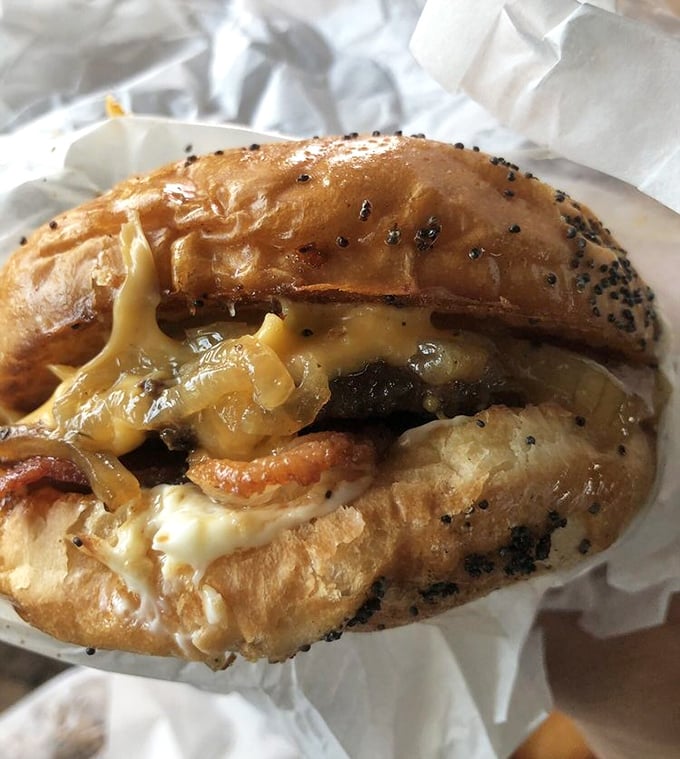 Grilled onions cascading over melted cheese and beef&mdash;this isn't just a burger, it's a symphony of flavors conducted by decades of drive-in expertise.