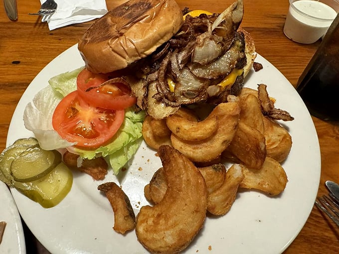 Burger architecture at its finest &ndash; a towering masterpiece of beef, bacon, and cheese that requires both strategic planning and a healthy appetite.