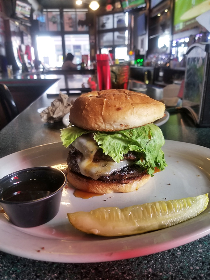 This burger towers with the kind of confidence that only comes from knowing you're absolutely, positively delicious.