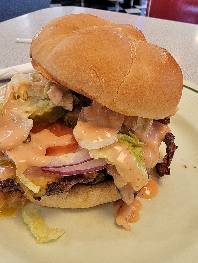 A burger that doesn't need fancy aioli or truffle oil to impress&mdash;just honest ingredients stacked high enough to require jaw exercises.