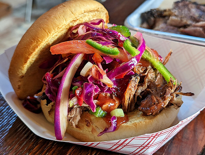 The sandwich that launched a thousand napkins. Colorful slaw provides the perfect crunchy counterpoint to tender, smoky meat on a pillowy bun.
