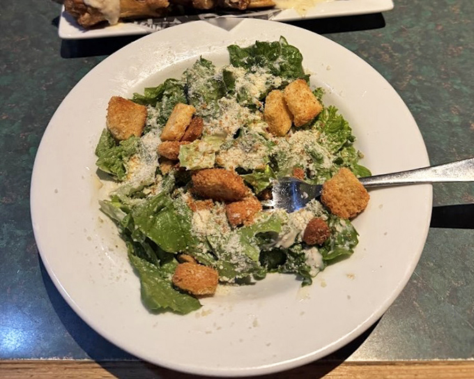Even the Caesar salad gets the respect it deserves, with generous shavings of parmesan and house-made croutons that could stand as a meal themselves if you weren't surrounded by smoked meat temptation.