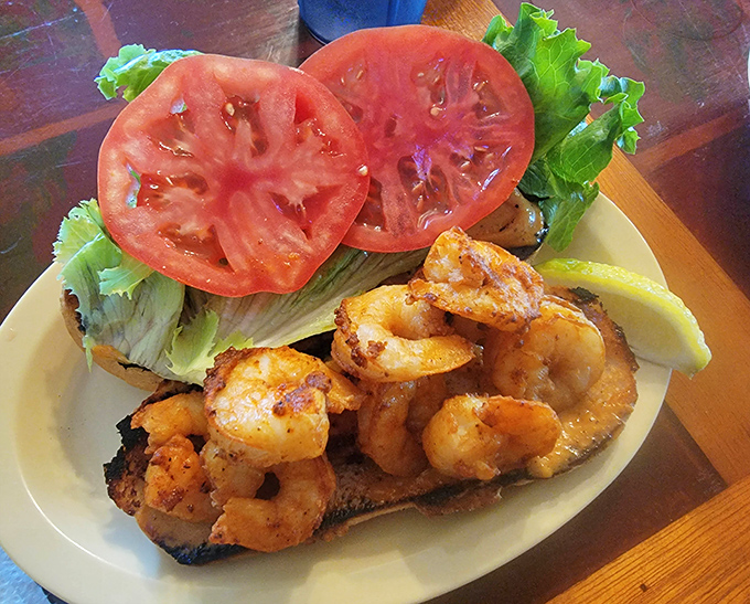 The Cajun shrimp po' boy: where plump, spicy shrimp meet garden-fresh veggies in a sandwich that demands to be photographed before it's devoured.