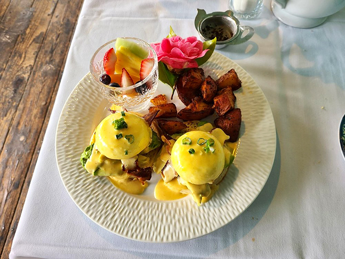 Eggs Benedict gets the California treatment with perfectly poached eggs, golden hollandaise, and a fruit garnish that makes vitamins feel indulgent.