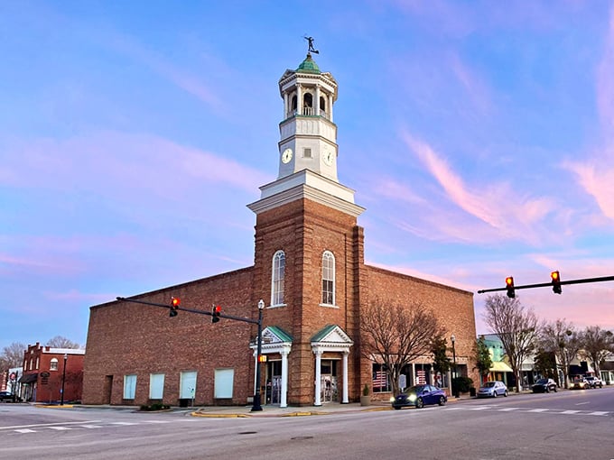 The Camden clock tower glows at sunset, standing sentinel over a downtown that refuses to surrender to chain-store sameness.