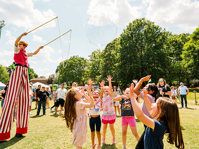 Nothing captures small-town magic like children reaching for giant bubbles at the Carousel Festival, their faces pure wonder.