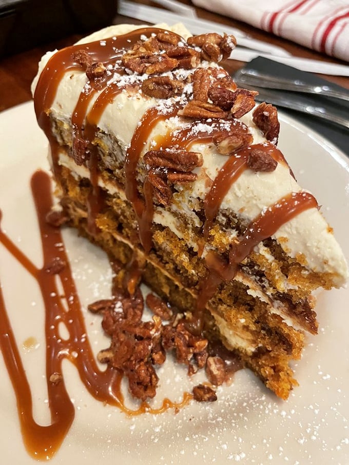 This isn't just carrot cake&mdash;it's an architectural masterpiece of cream cheese frosting, candied pecans, and caramel that demands to be photographed before devoured.