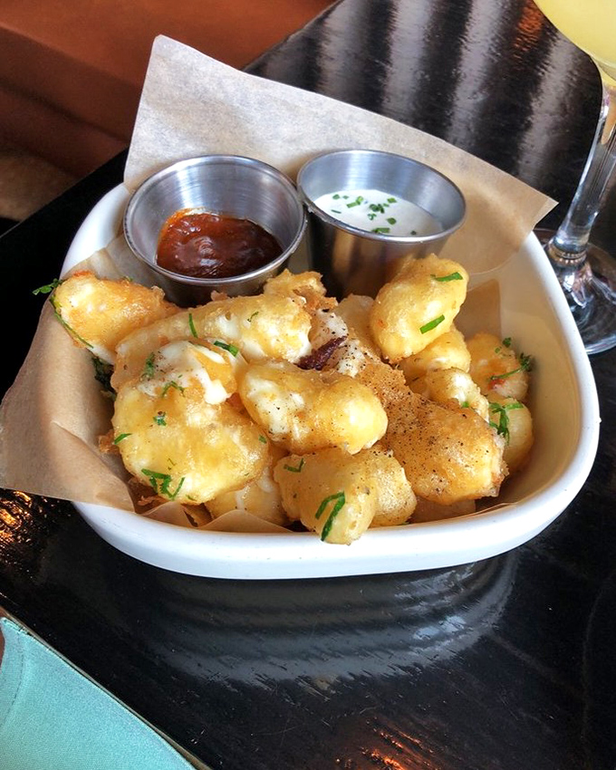 Cheese curds that squeak with Wisconsin pride, served with dipping sauces that elevate them from state fair favorite to culinary revelation.