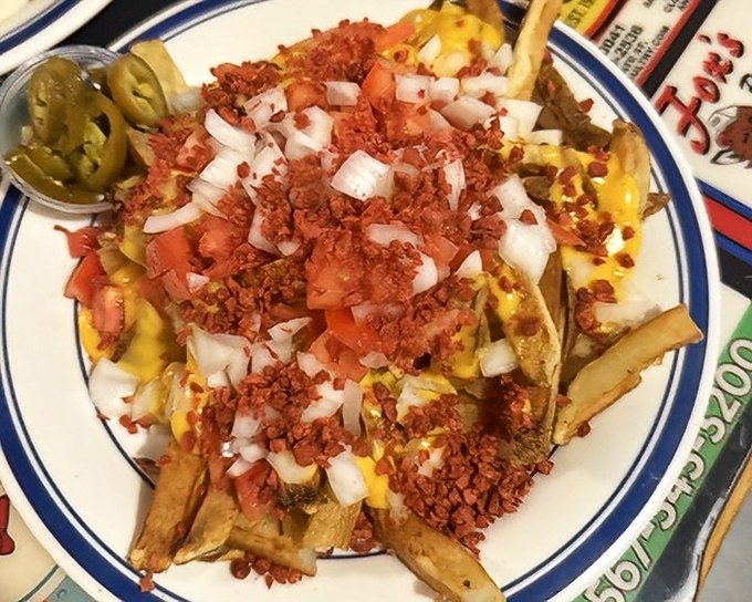 These loaded fries aren't just a side dish—they're a main event topped with enough cheese, bacon, and jalapeños to make a potato proud.