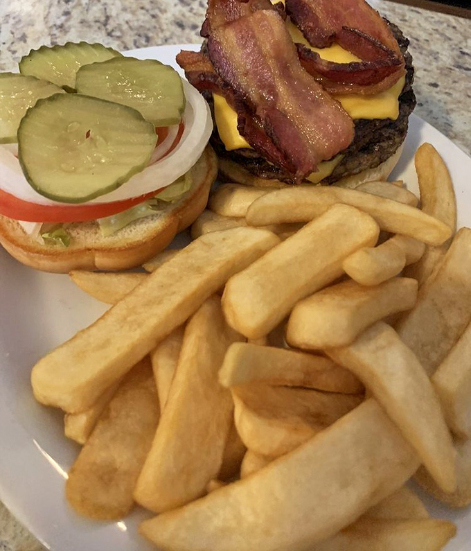 This isn't just a cheeseburger; it's a masterclass in American cuisine. The bacon is practically doing a victory dance atop that perfectly melted cheese.