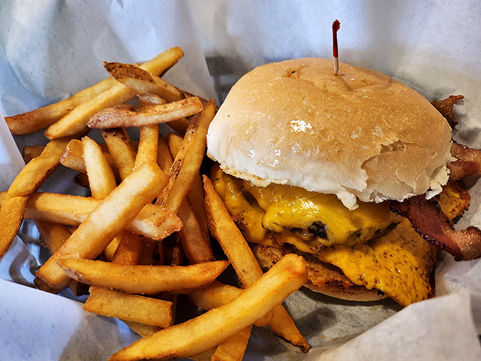 The holy trinity of comfort food: golden fries, melty cheese, and a burger that requires both hands and several napkins. Worth every delicious calorie.