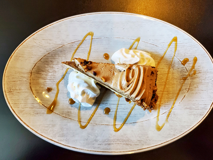 Dessert architecture at its finest. This cheesecake slice with its artistic caramel drizzle proves that Pennsylvania knows its way around the sweet stuff,