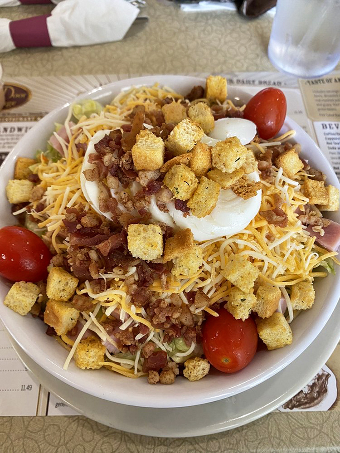 A chef's salad that doesn't skimp on the good stuff&mdash;cheese, croutons, and enough bacon bits to make even a lettuce skeptic reconsider their position.