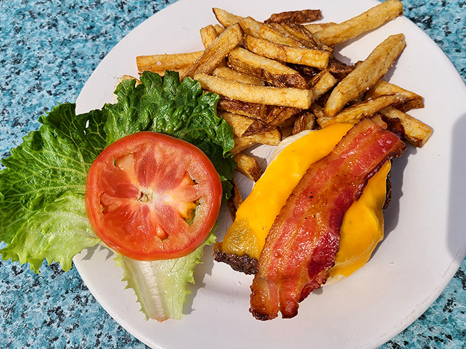 This isn't just a burger; it's a masterpiece of melty cheese, crispy bacon, and fresh veggies. The kind of sandwich that makes you forget table manners exist.