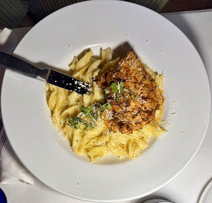 Creamy alfredo sauce embraces perfectly cooked pasta like an Italian grandmother hugging you after too long apart. The chicken adds substance without stealing the show.