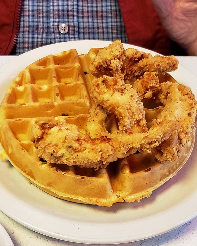 The ultimate breakfast compromise: a golden waffle playing host to perfectly crispy chicken. It's the breakfast equivalent of having your cake and eating it too.