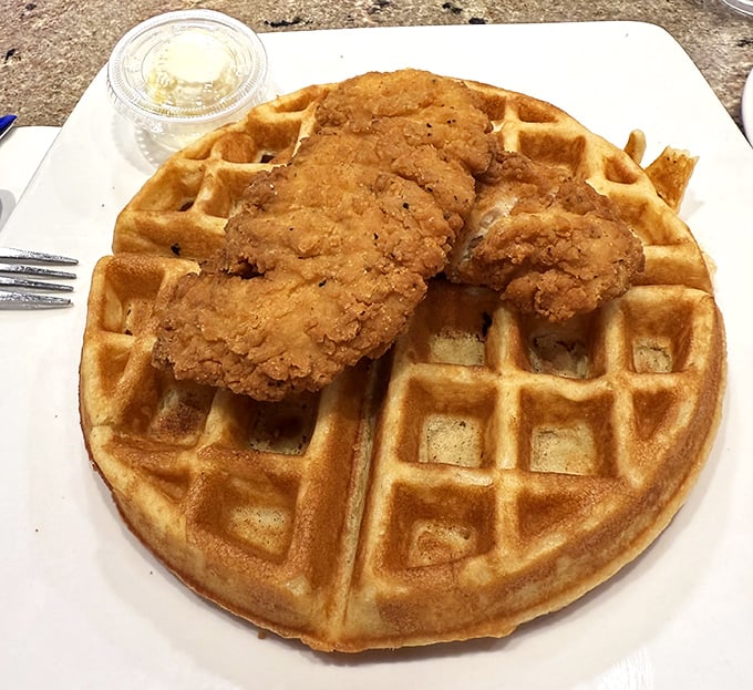 The ultimate breakfast compromise: a golden waffle and crispy chicken living together in perfect harmony, like a culinary Brady Bunch.