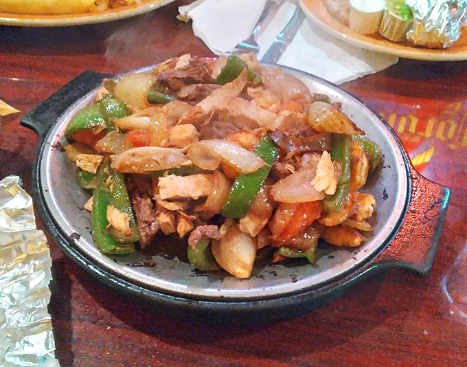 Sizzling fajitas that announce their arrival before you see them&mdash;a symphony of chicken, peppers, and onions performing on a hot skillet.