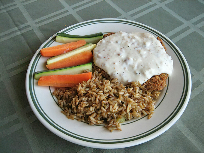 Country cooking meets California comfort in this chicken fried steak, smothered in creamy gravy alongside rice and fresh vegetables. Grandma would be jealous.