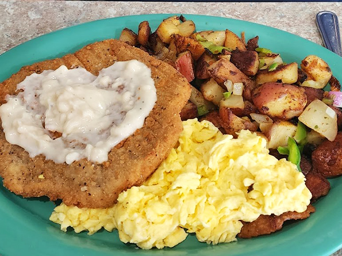 Country fried steak with gravy that could make a vegetarian question their life choices, paired with eggs that practically glow with morning sunshine.