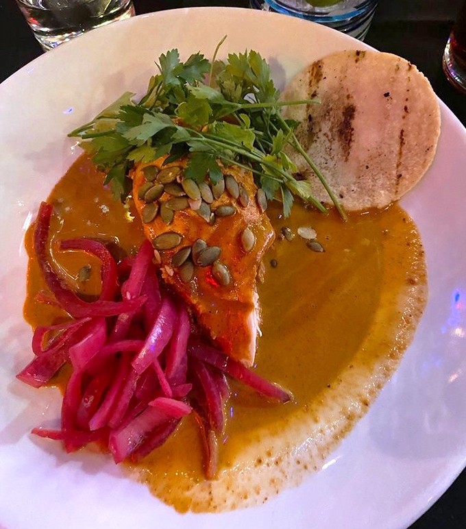 This chicken mole plate, adorned with vibrant pickled onions and pepitas, is like Mexico's answer to the perfect color wheel of flavors.