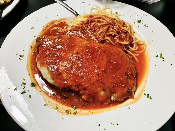 Chicken Parmesan that doesn't know the meaning of "portion control." That sauce has clearly been simmering since breakfast.
