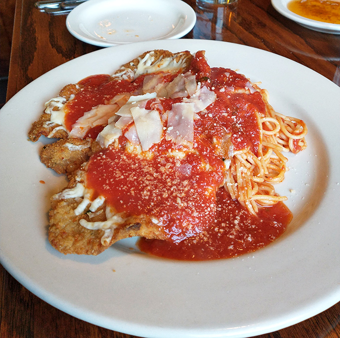 Chicken Parmigiana: where a perfectly crisp cutlet meets vibrant tomato sauce in a marriage so perfect it deserves its own anniversary celebration.
