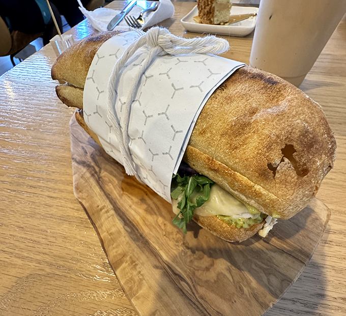 Sandwich architecture at its finest. Crusty artisanal bread cradles fresh ingredients with the structural integrity that would make Frank Lloyd Wright proud.