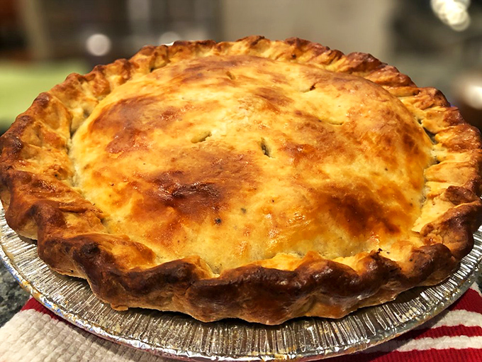 Golden crust concealing comfort food treasures within - the kind of pie that makes grown adults skip dinner.