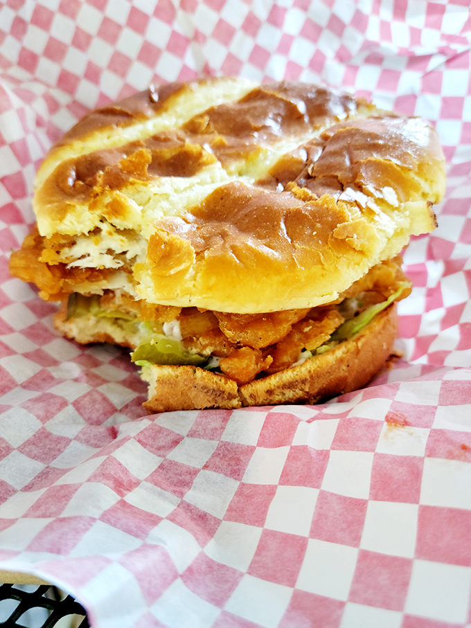 Sandwich architecture at its finest! This chicken tenderloin creation defies gravity with its towering crispy goodness and fresh toppings.