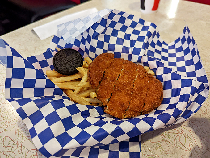 Golden-brown chicken strips nestled beside crispy fries&mdash;comfort food that whispers, "Everything's going to be okay," with every crunchy bite.