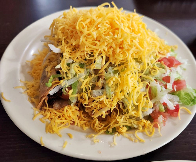 Cheese mountain alert! What lies beneath this glorious avalanche of shredded cheddar is anybody's guess, but I'm willing to excavate one delicious bite at a time.