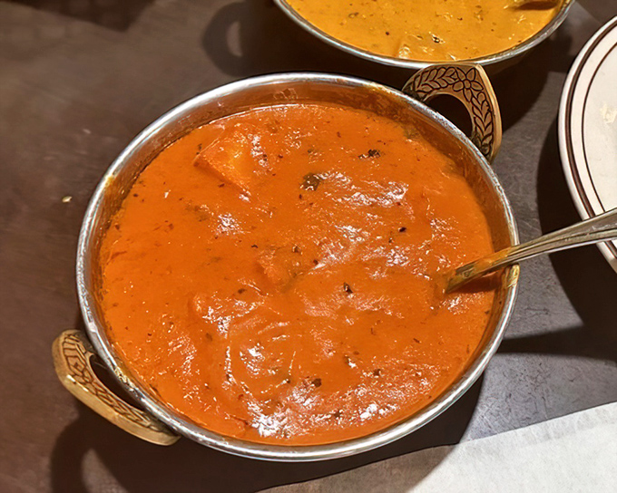 Behold the chicken tikka masala—that perfect orange glow promising creamy, tomato-rich comfort that's worth every napkin you'll need.
