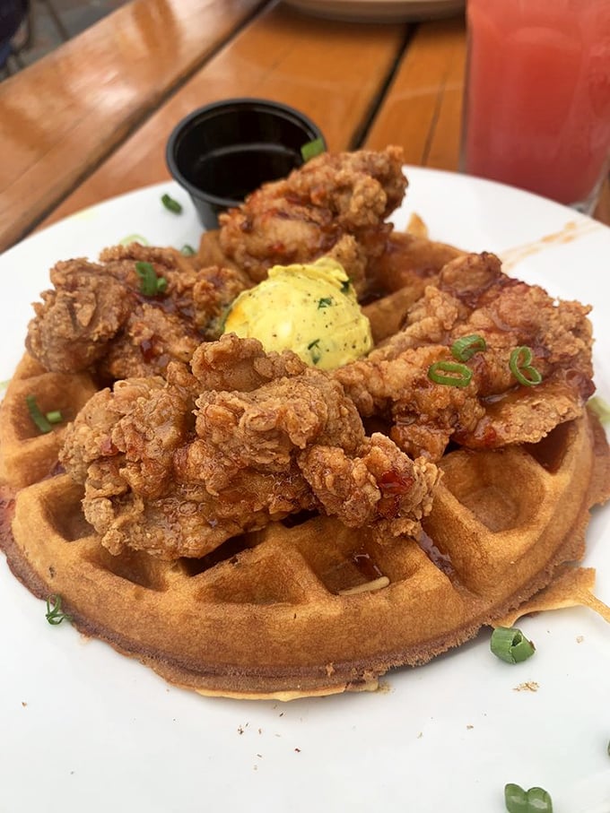 Chicken and waffles: where breakfast and dinner have a delicious identity crisis on a plate, topped with a dollop of herb-flecked butter.