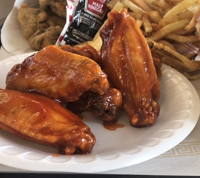 Wings glistening with sauce that means business. The kind that make you forget about napkins until it's way too late.