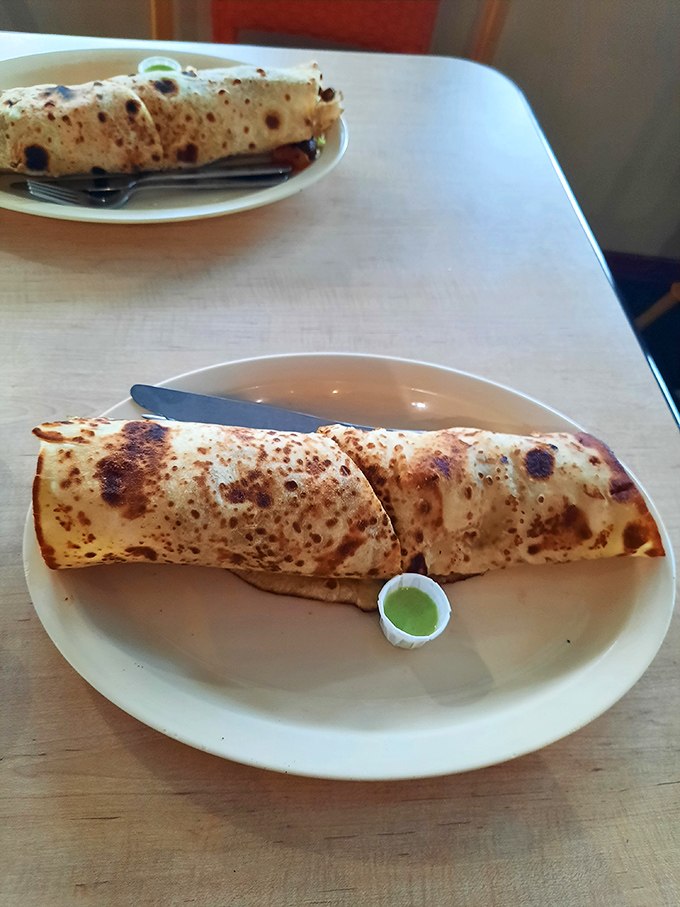 Behold the chicken wrap&mdash;where East African spices meet convenient handheld dining. That charred exterior promises flavor depths worth exploring.