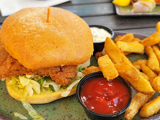 This isn't just a sandwich; it's an engineering marvel of crispy fish, fresh toppings, and a bun that somehow contains the delicious chaos.
