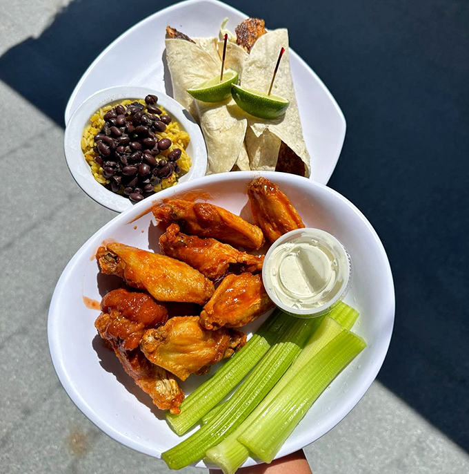 Buffalo wings that demand to be noticed, served with celery sticks that nobody asked for but tradition demands.