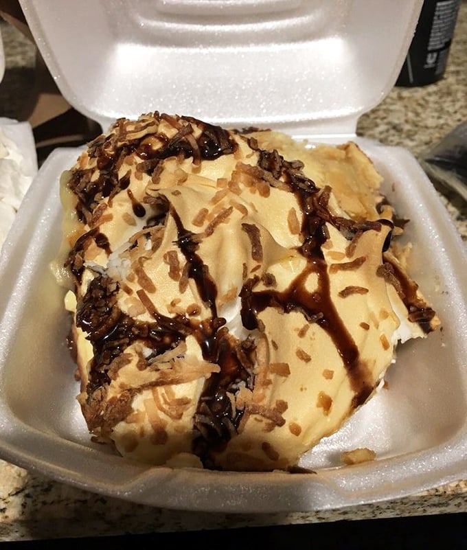 Chocolate coconut cream pie with a drizzle of chocolate sauce&mdash;proof that sometimes the best things in life come in styrofoam containers. 