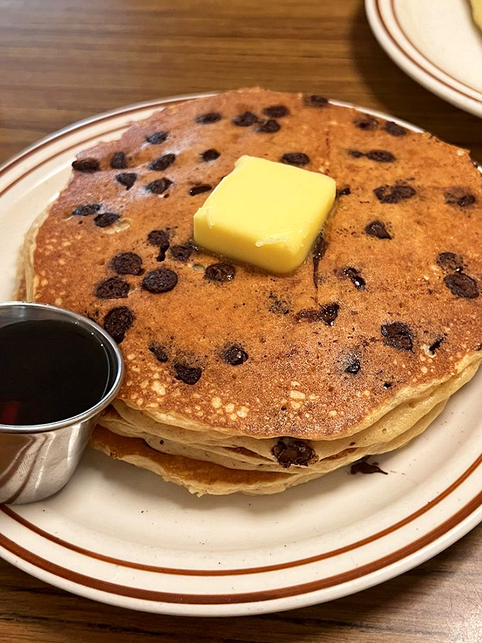 Chocolate chip pancakes that make you question why you ever ate cereal. That pat of butter melting on top is performing a slow dance of deliciousness.