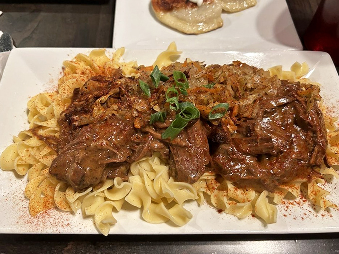Comfort food royalty: fork-tender pot roast over homemade noodles. The kind of dish that makes you want to cancel your evening plans and surrender to carb bliss.