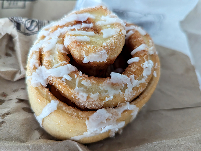 The cinnamon roll glistens with icing like it's auditioning for a pastry calendar&mdash;the kind of breakfast indulgence worth setting your alarm for.