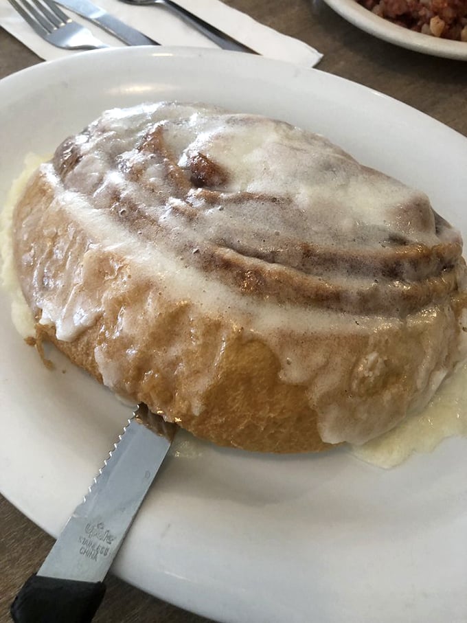 That cinnamon roll isn't just breakfast&mdash;it's an architectural achievement with a sweet glaze waterfall cascading down buttery layers.