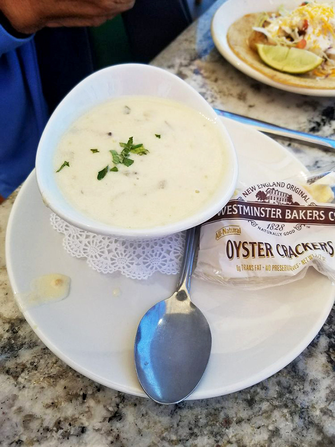 A bowl of New England clam chowder so creamy and comforting, it could make a foggy day at the harbor feel like a warm hug.