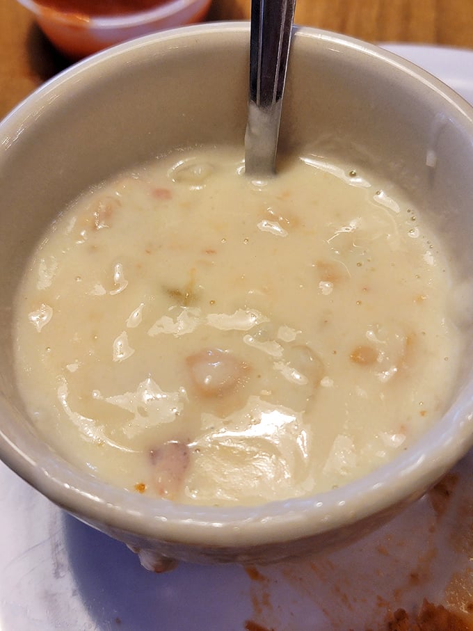Creamy clam chowder that whispers of coastal kitchens &ndash; a spoonful of ocean comfort nestled in the Tennessee mountains.