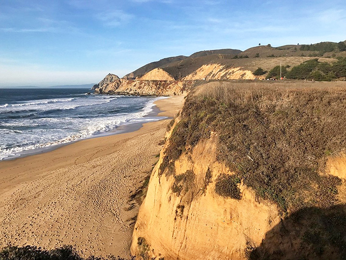 Nature's perfect viewing platform, where golden cliffs stand guard over pristine sands, inviting you to pause and remember how small we truly are.