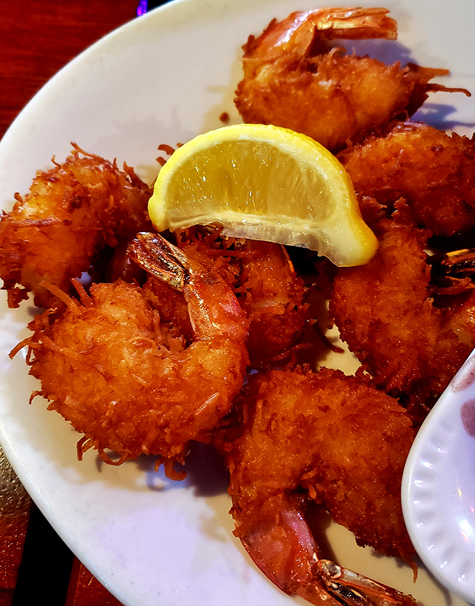 The legendary coconut shrimp&mdash;crispy, golden halos surrounding sweet Gulf shrimp. That lemon wedge isn't just garnish; it's the perfect acidic counterpoint.